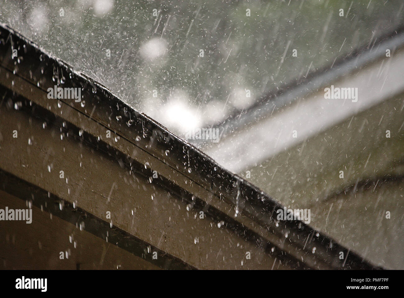 Rain coming off the side of the roof of house Stock Photo - Alamy