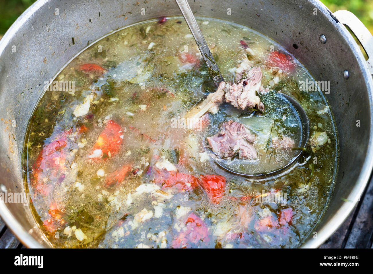 top view of cooking central asian shurpa (soup from meat and large ...
