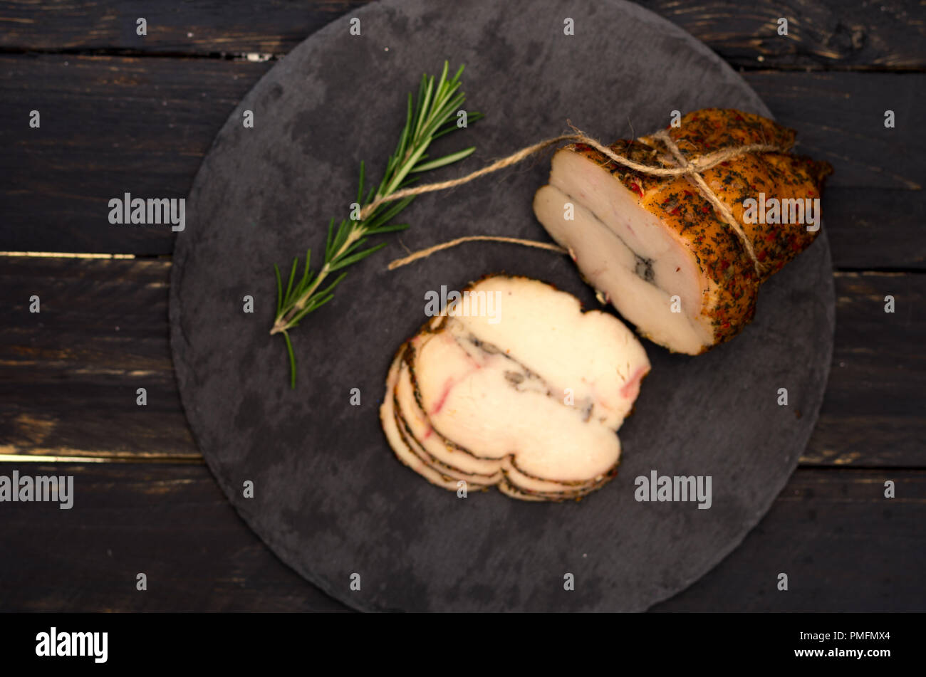 Cutting the meat into pieces. Baked chicken roll. Top view Stock Photo ...