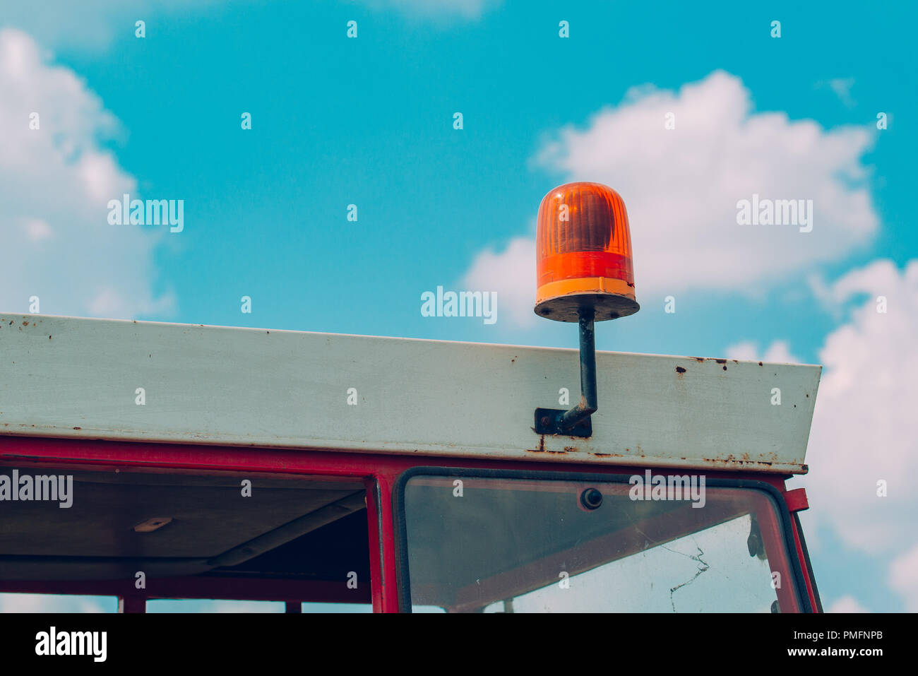 Old tractor beacon light mounted on the roof of agricultural vehicle ...