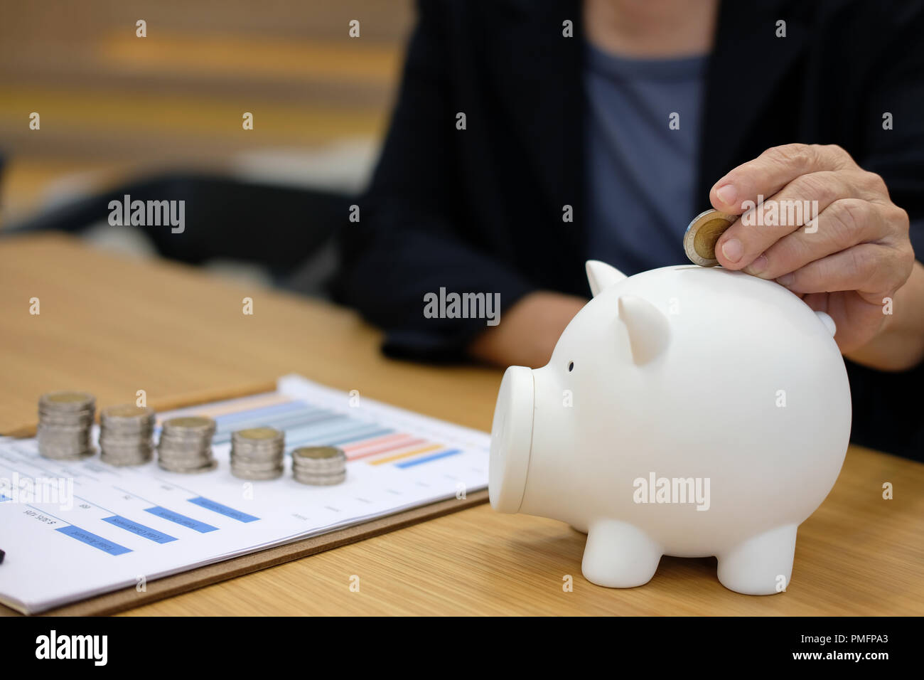 hand put coin in piggy bank. money savings, cash deposit concept Stock ...