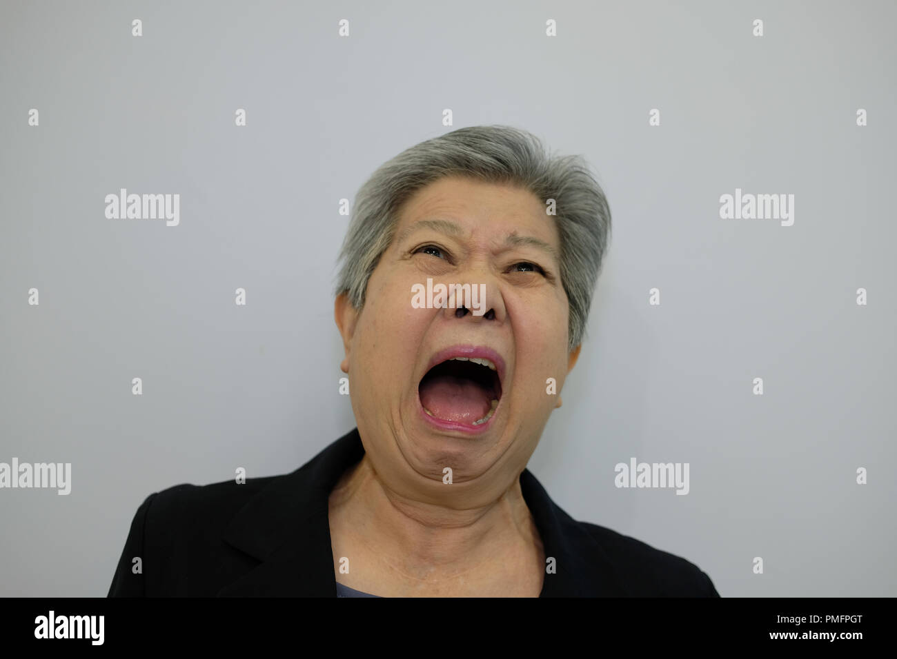 scared elder woman. frightened elderly female. surprised asian senior ...