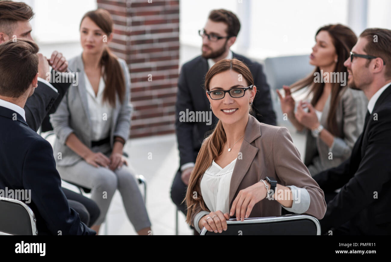 business woman sitting in a circle with a business team Stock Photo - Alamy