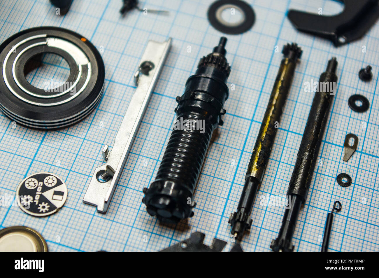 parts are completely disassembled old retro film SLR camera on graph ...