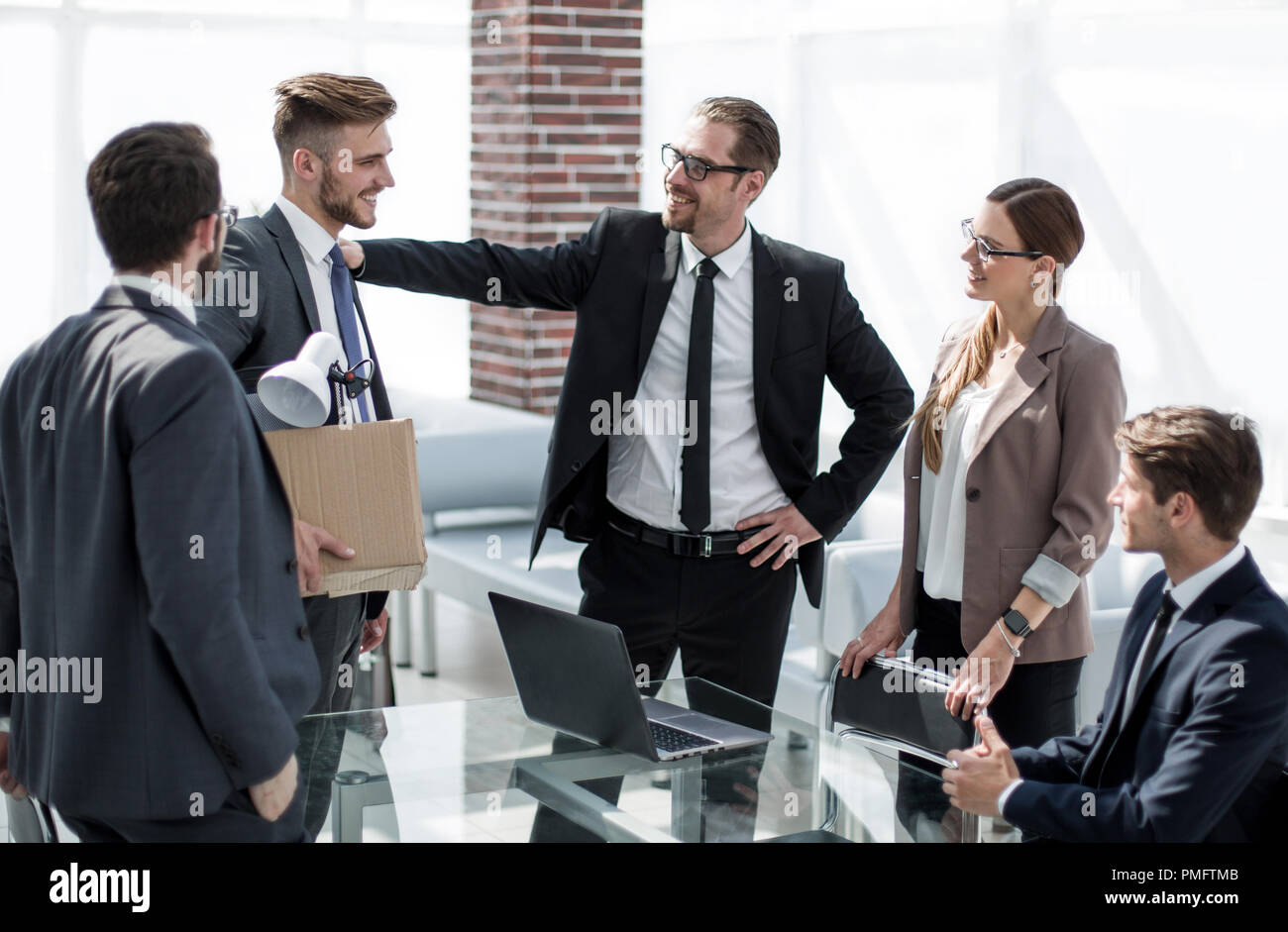 Manager introduces a new employee to the business team Stock Photo - Alamy