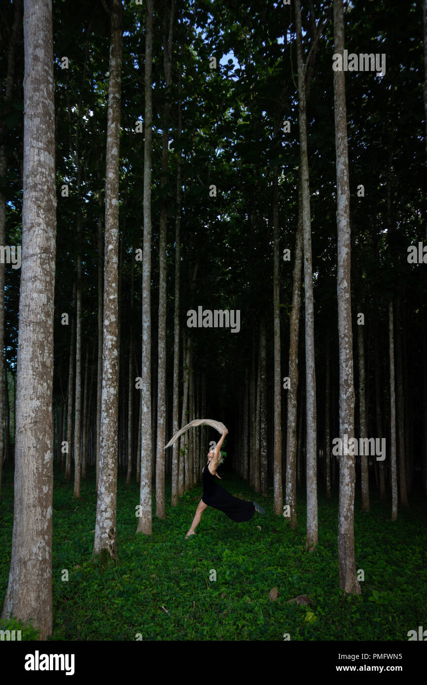 Carefree woman dancing through the forest Stock Photo - Alamy