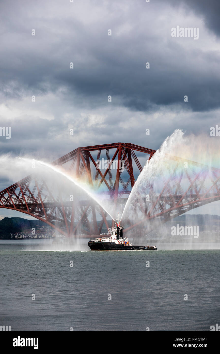 Tug boat using water cannon at Forth Bridge Stock Photo - Alamy