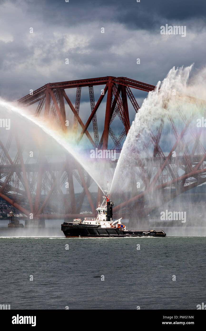 Tug boat using water cannon at Forth Bridge Stock Photo - Alamy
