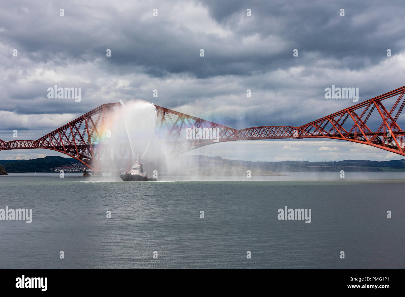 Tug boat using water cannon at Forth Bridge Stock Photo - Alamy