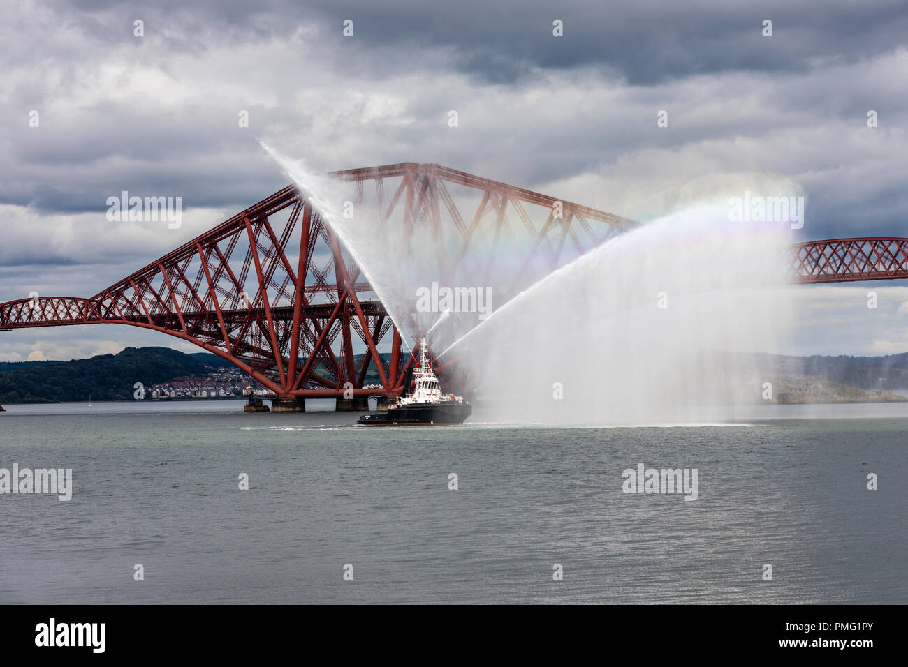 Tug boat using water cannon at Forth Bridge Stock Photo - Alamy