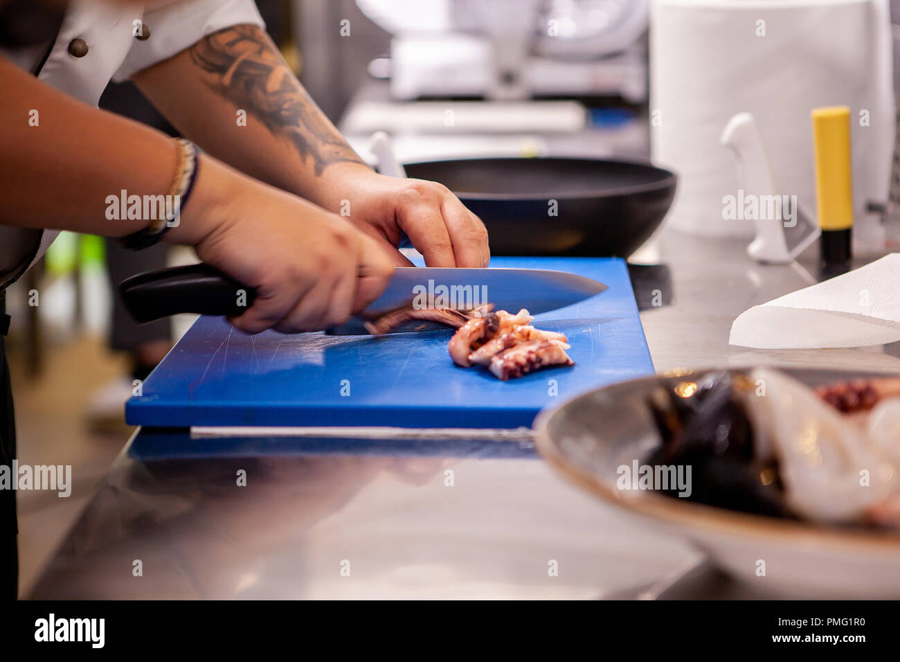 Male cook slicing seafood in restaurant kitchen.Delicious food Stock ...