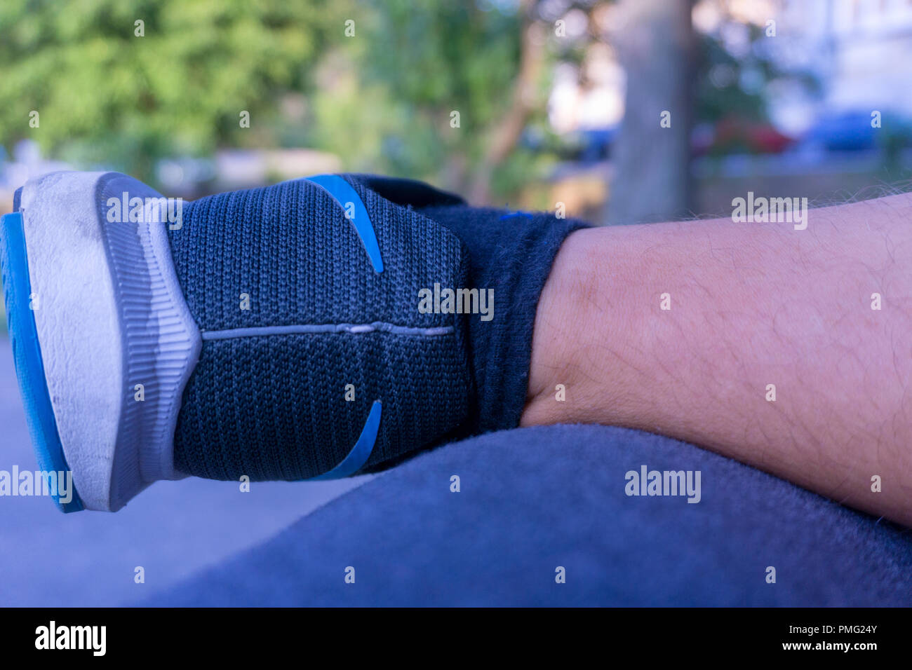 Resting on a bench with legs crossed Stock Photo - Alamy