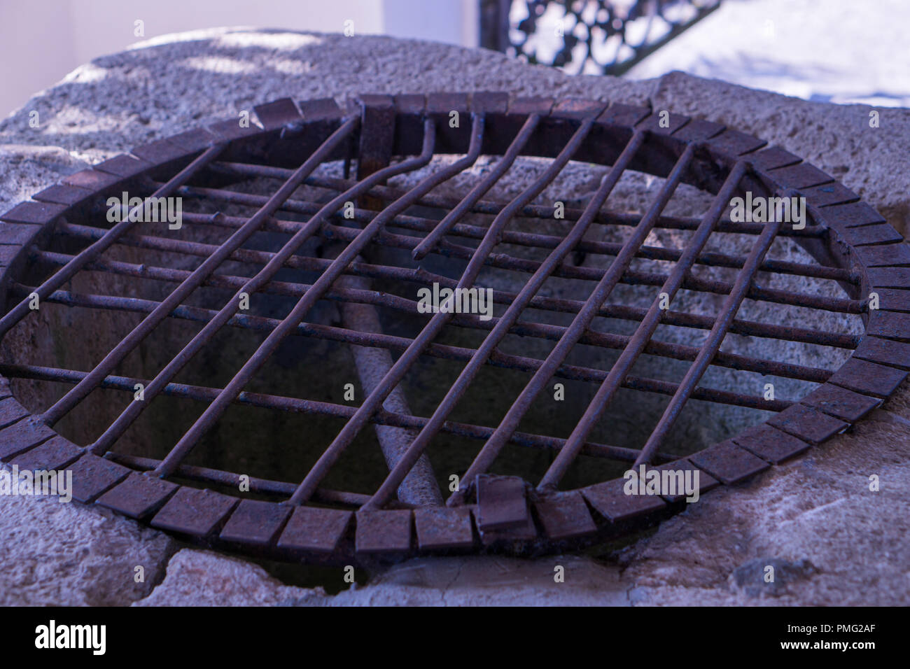 Old well with iron cover Stock Photo - Alamy