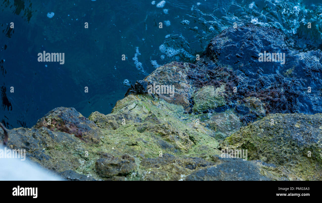 Colorful rocks submerging in the sea water Stock Photo - Alamy