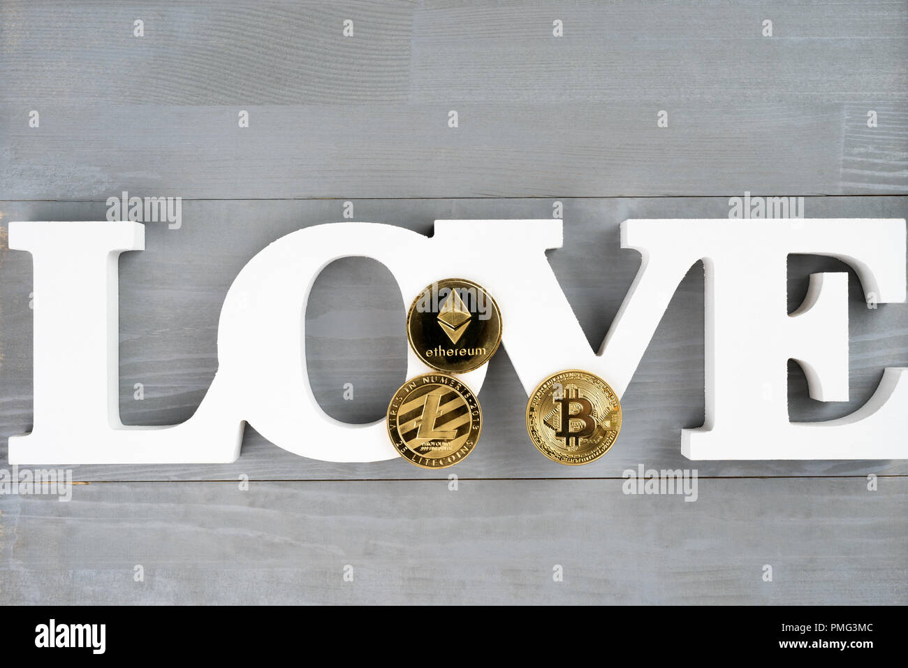 Gold physical Bitcoin, Litecoin and Ethereum coins on love inscription ...