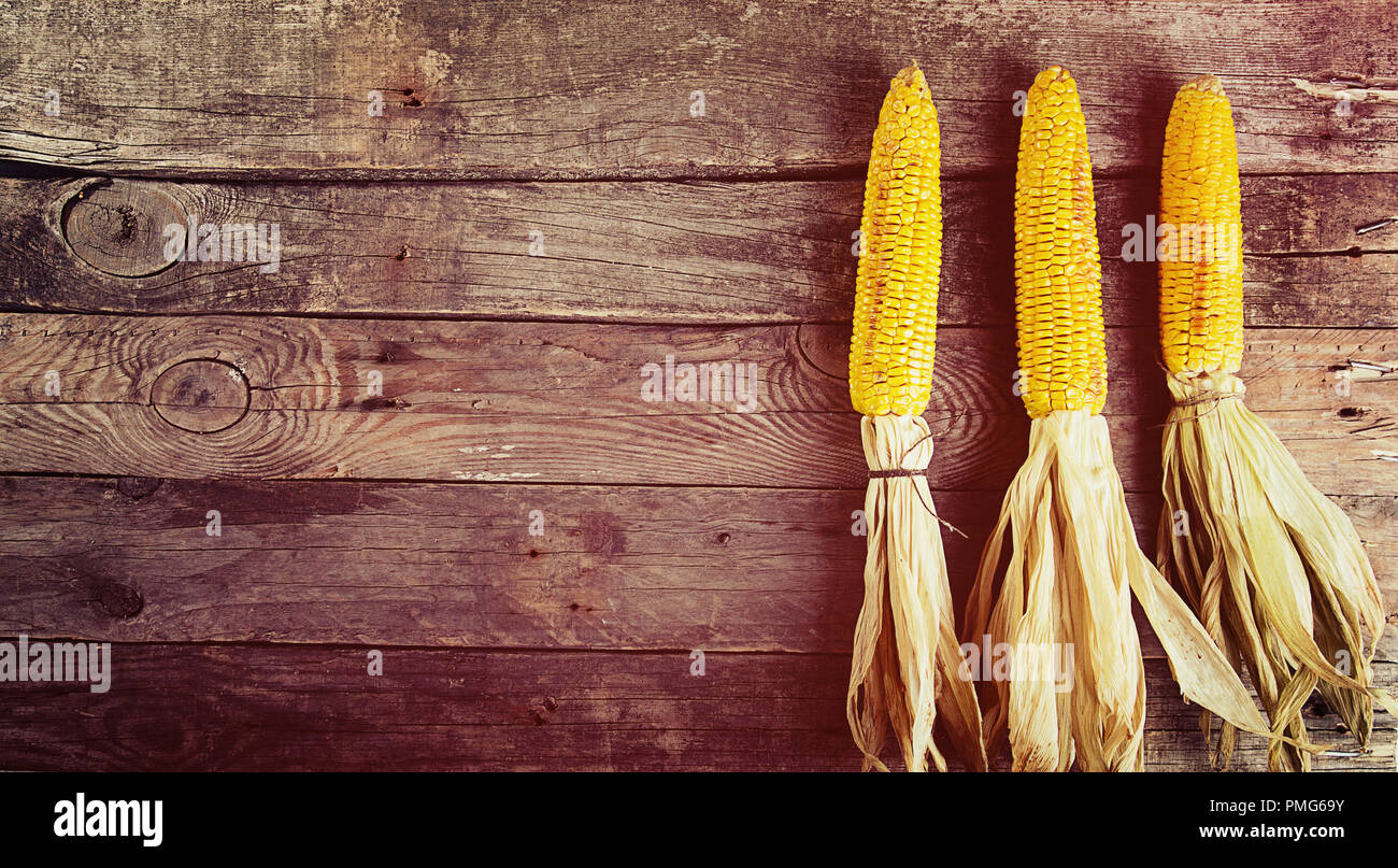 Grilled corn cobs on old wooden background. Top view. Copy space Stock ...