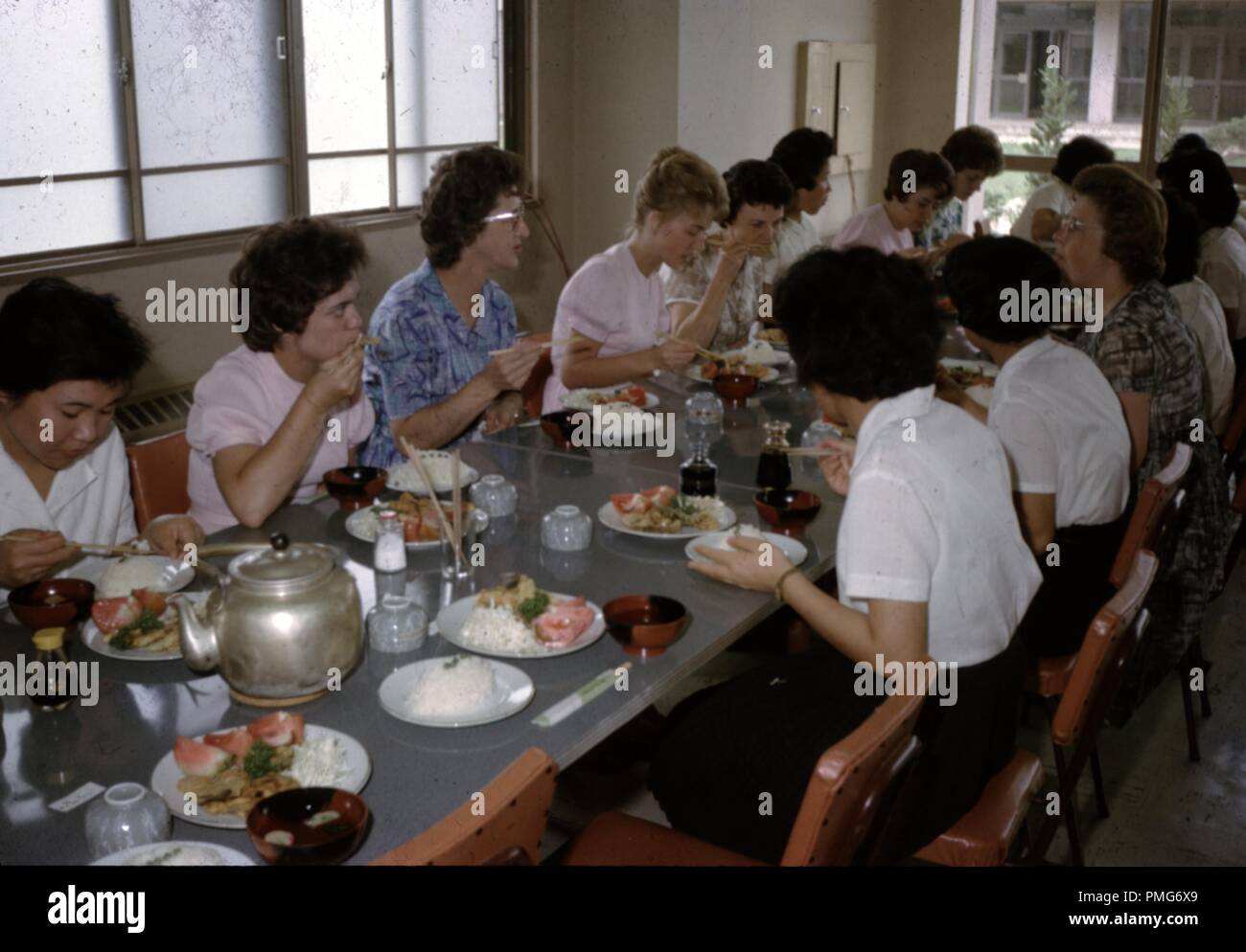 Female Christian missionaries and Japanese congregants dine together at ...