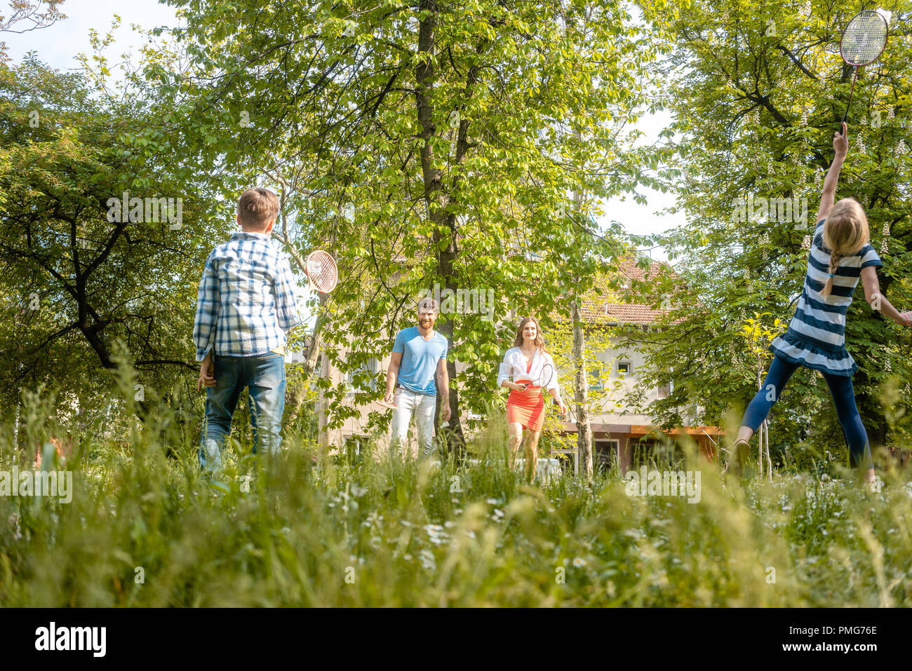 Family playing badminton on a meadow in summer Stock Photo - Alamy