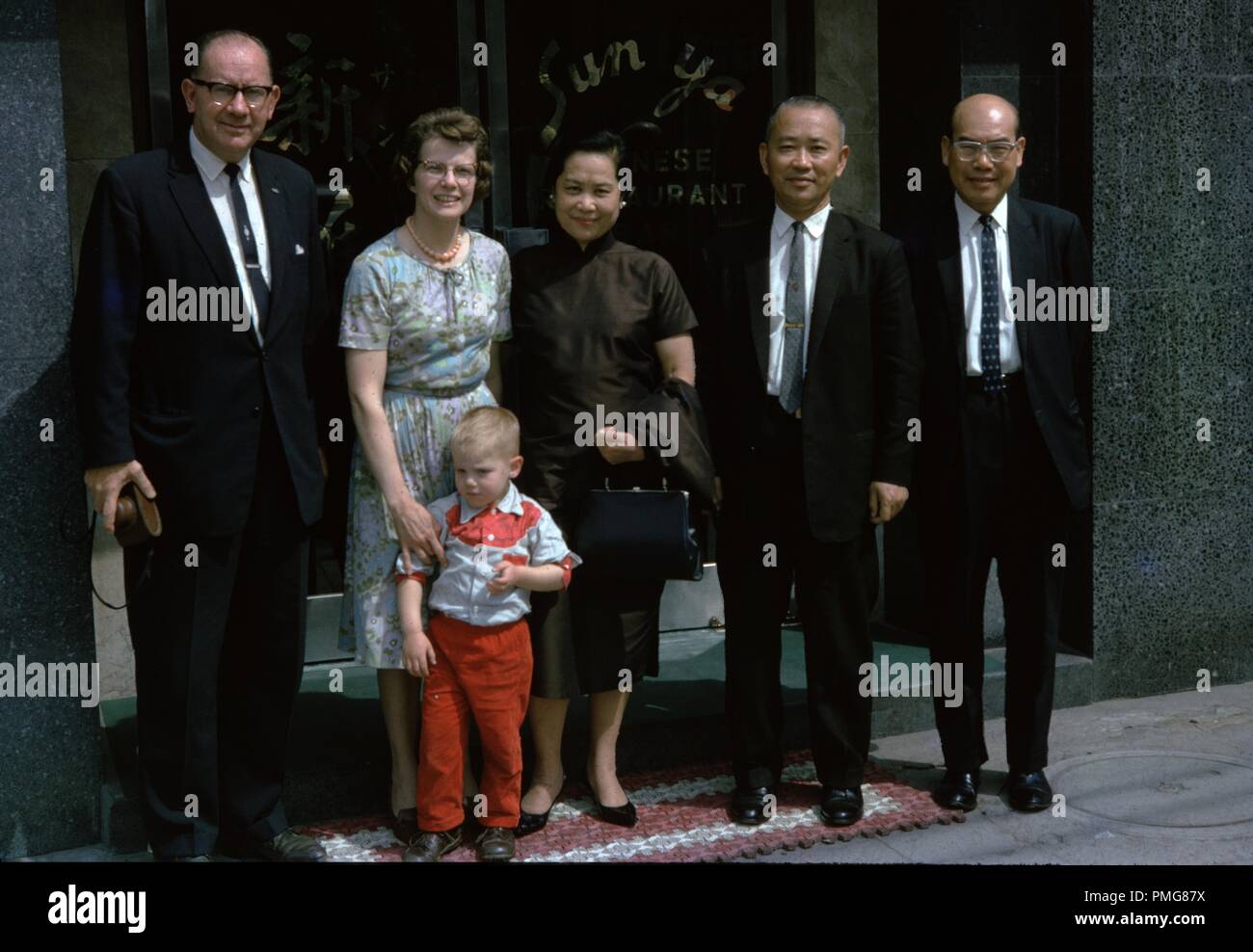 Family and friends posing for a photo in front of the Sun-Ya Chinese ...