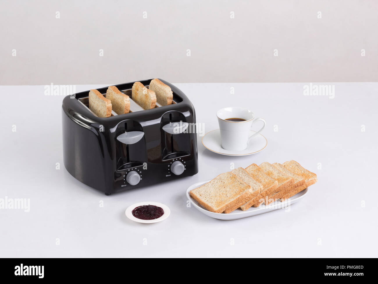 Bread toaster and bread isolated on white background Stock Photo - Alamy