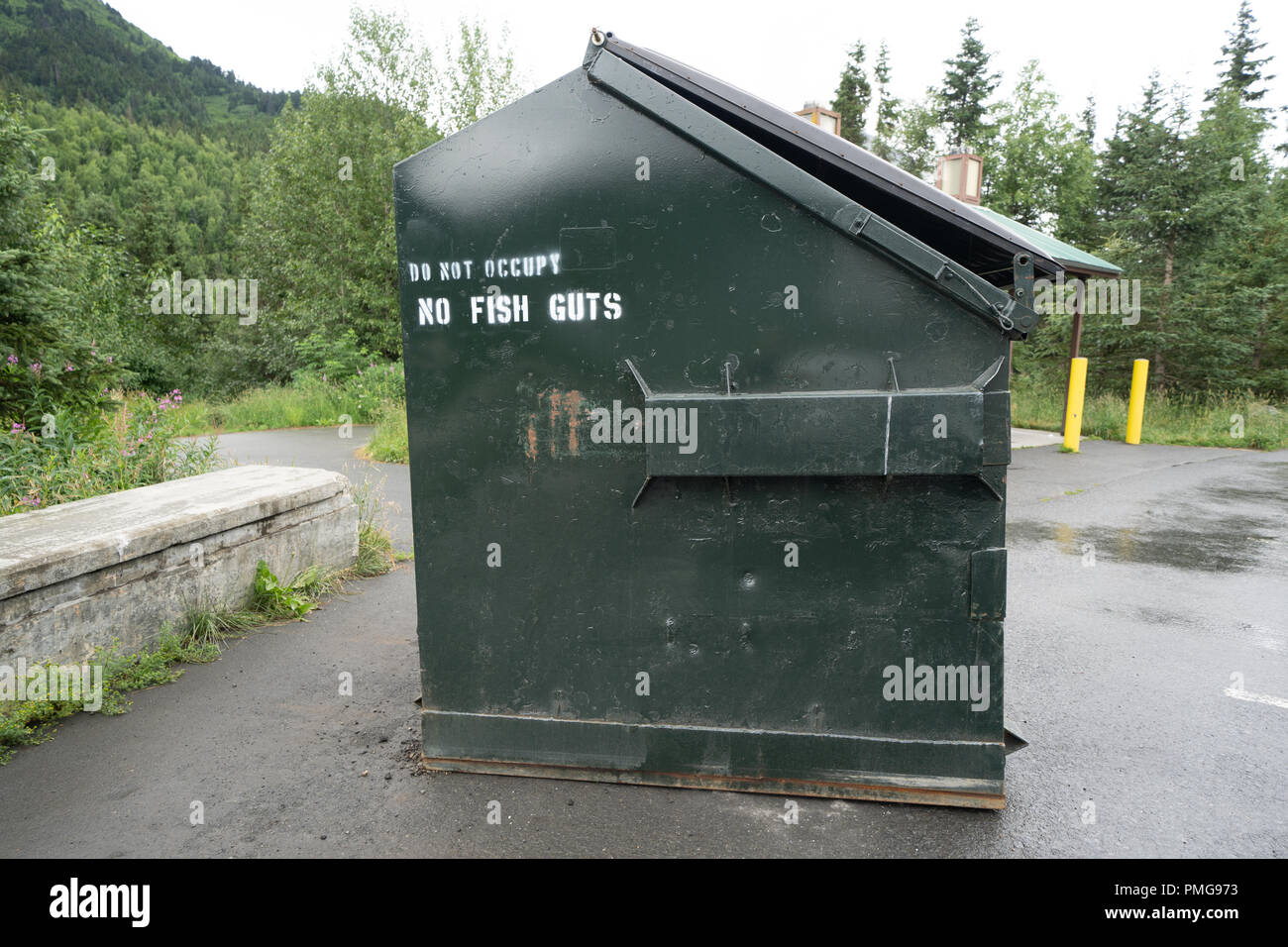 Large trash dumpster in Alaska specifies no fish guts Stock Photo - Alamy