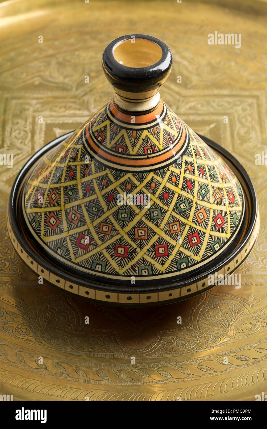 Traditional decorated Moroccan tagine made in Safi on a brass table ...