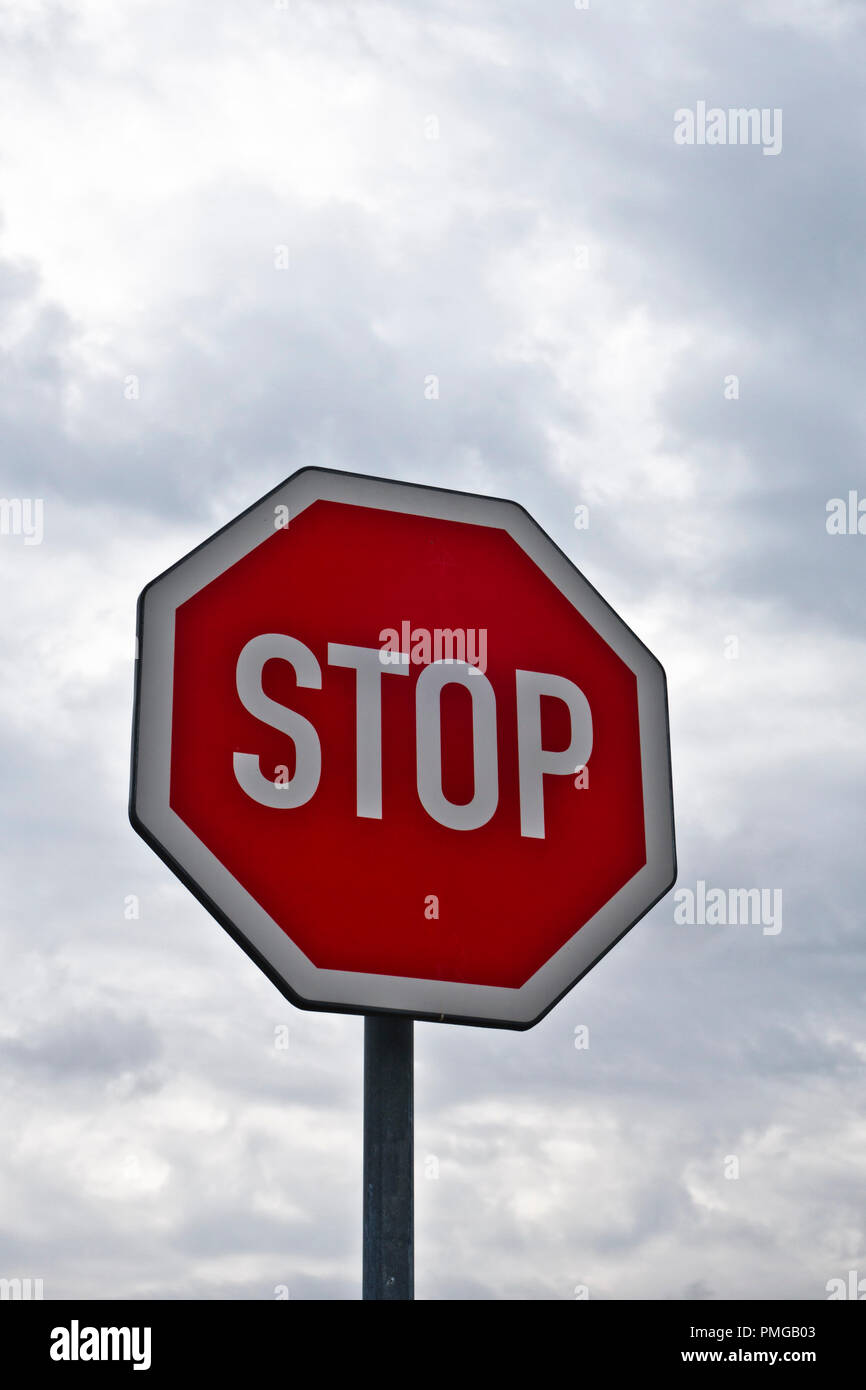 stop sign with dramatic sky behind, conceptual image Stock Photo - Alamy