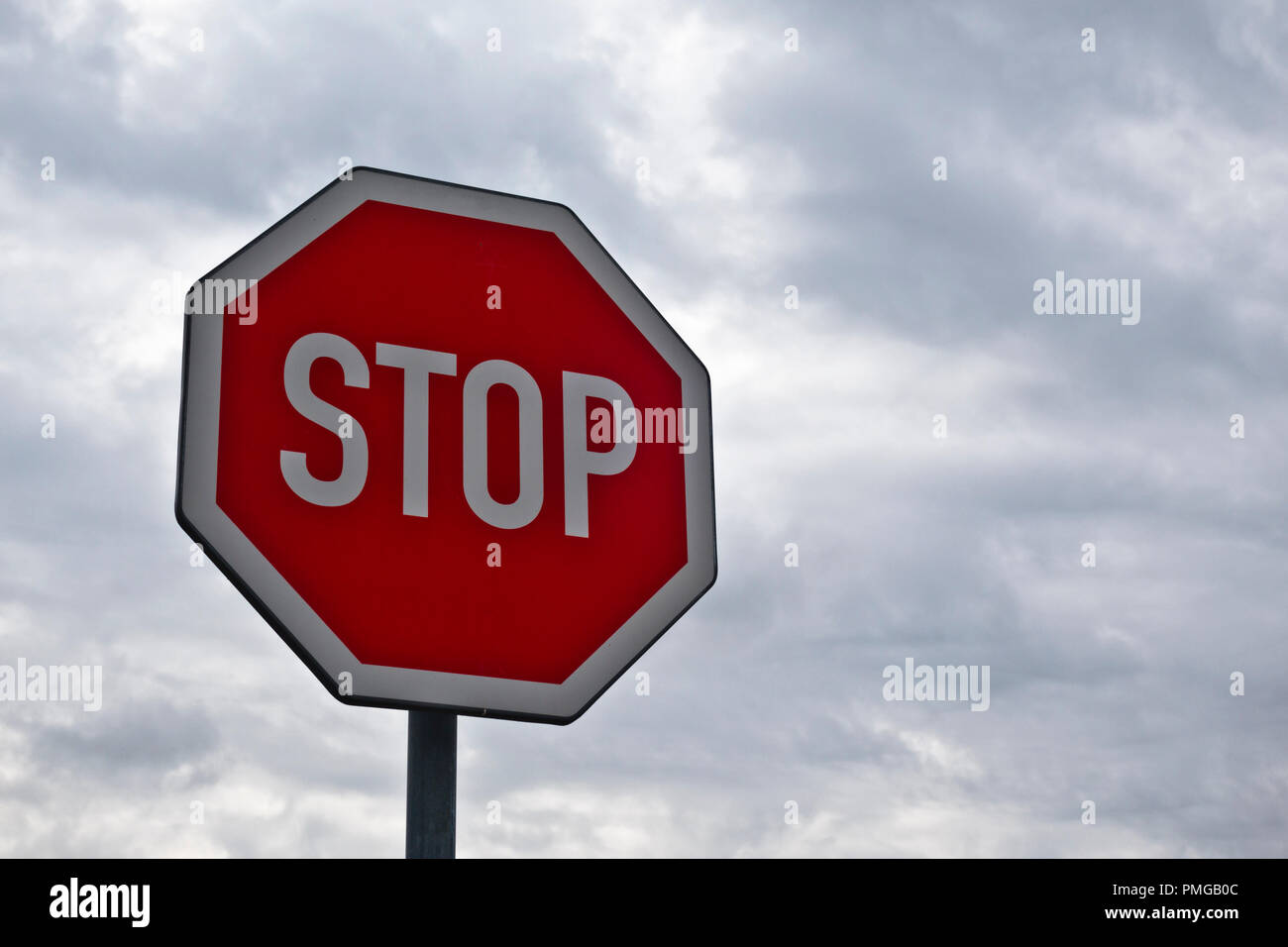 stop sign with dramatic sky behind, conceptual image Stock Photo - Alamy