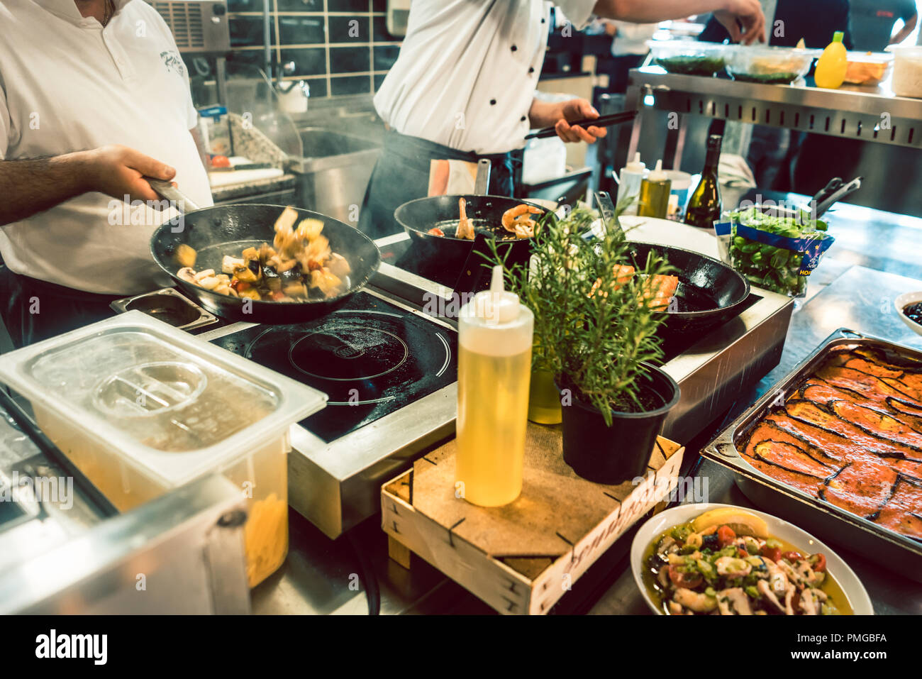 Various fresh ingredients on the stove of a commercial kitchen Stock ...