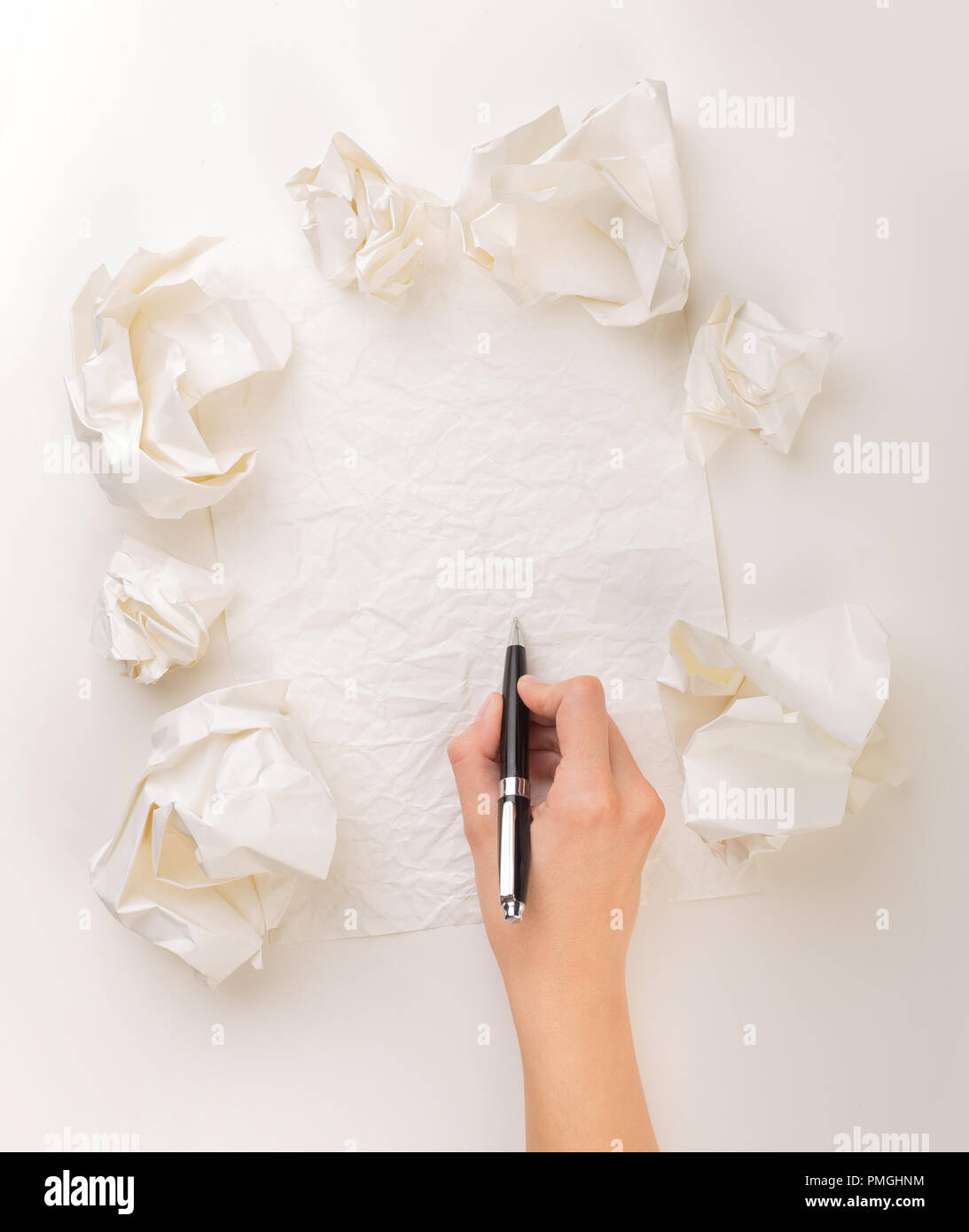 Female hand trying to write next to a few crumpled paper balls Stock ...