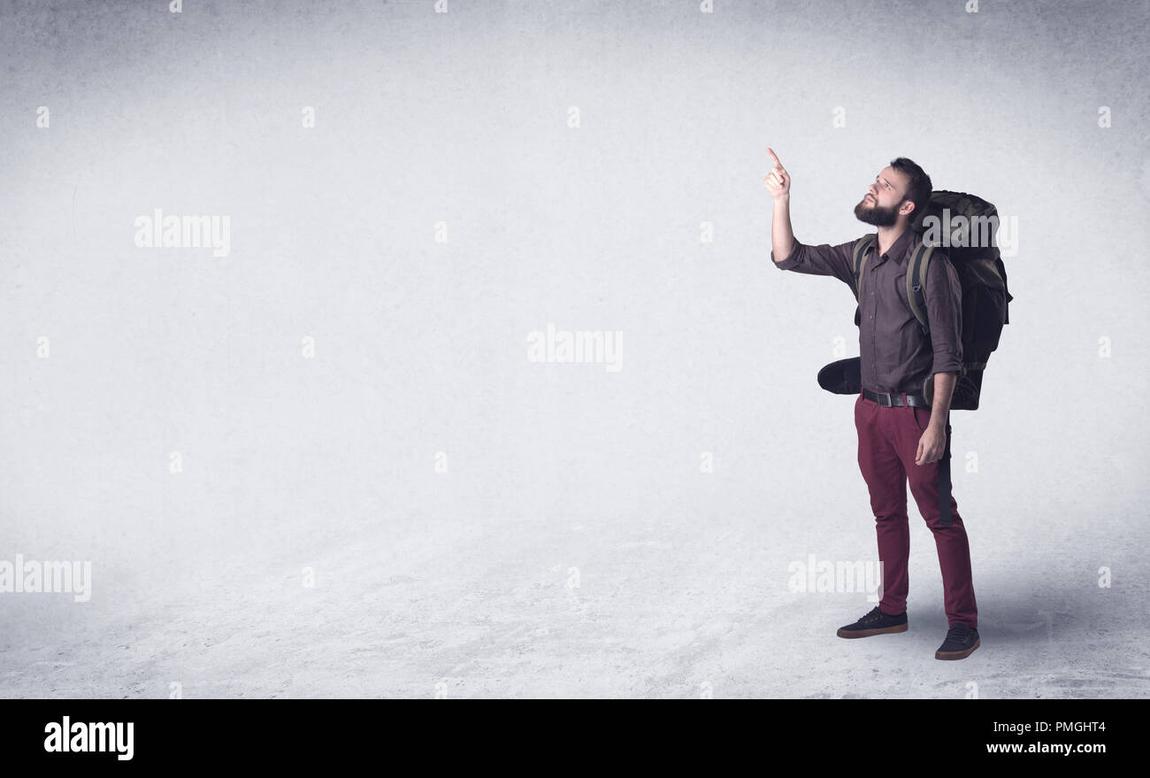 Standing handsome young man with a backpack Stock Photo - Alamy