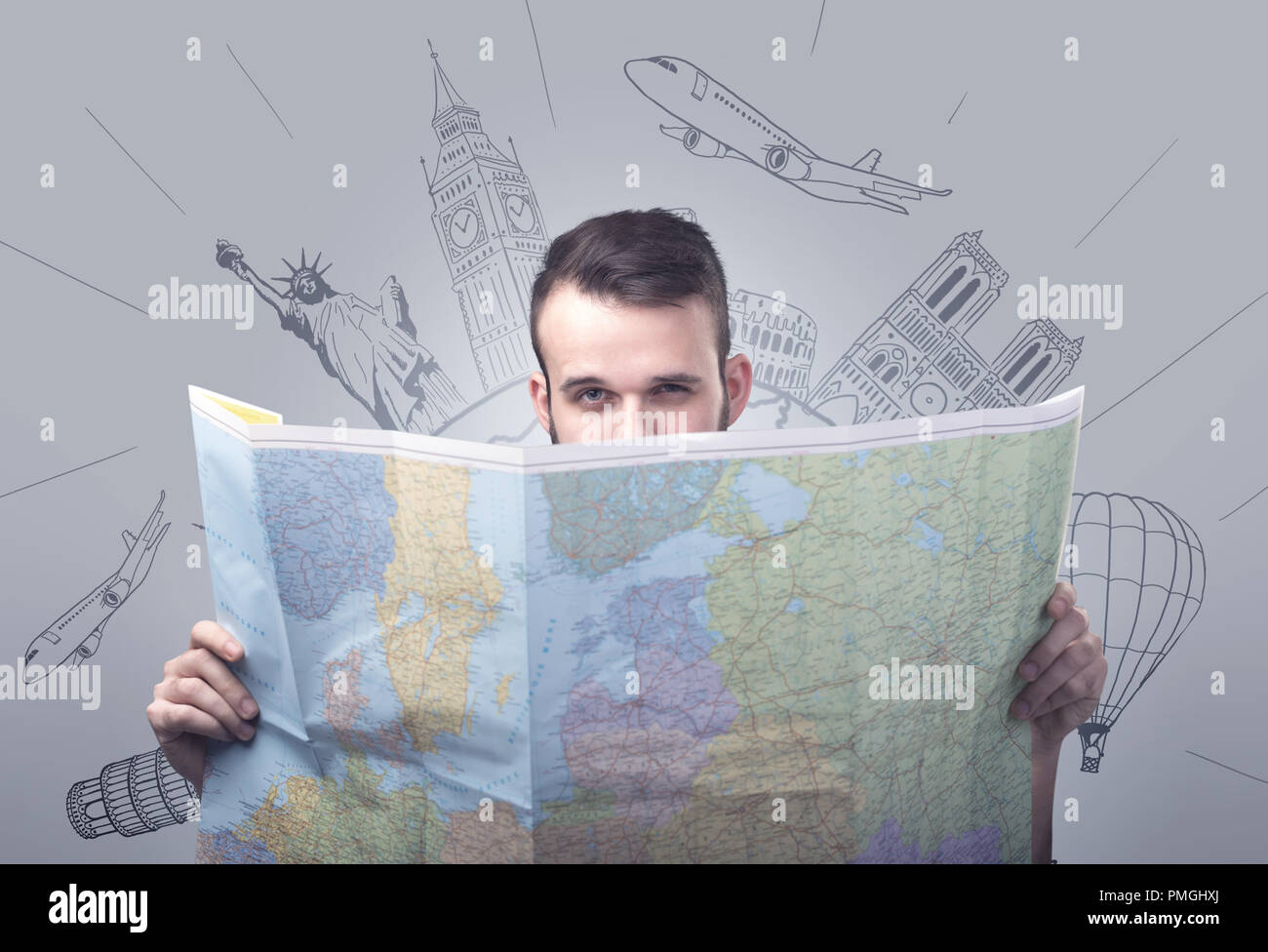 Handsome young man holding a map with famous sightseeing destinations ...