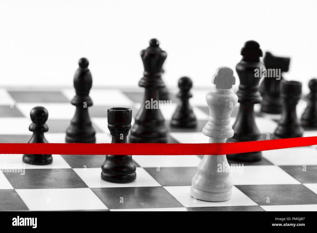 Chess leadership concept with King's figure crossing the red finish ...