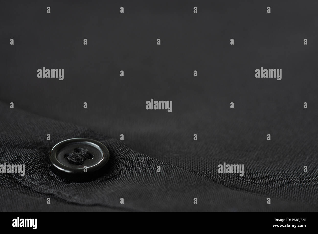 closeup detail shot of button on black shirt clothes Stock Photo - Alamy