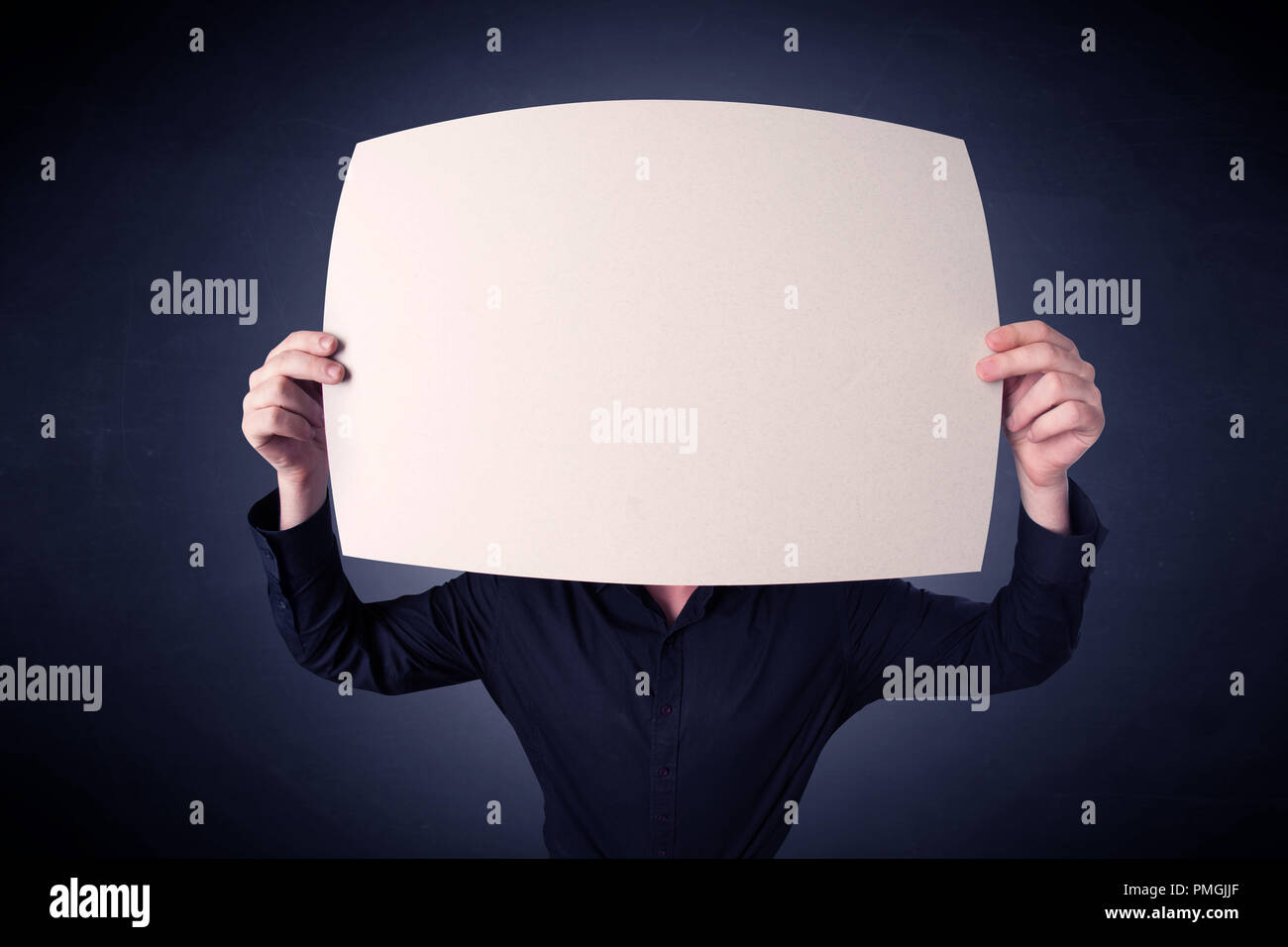 Young businessman hiding behind a blank piece of paper Stock Photo - Alamy