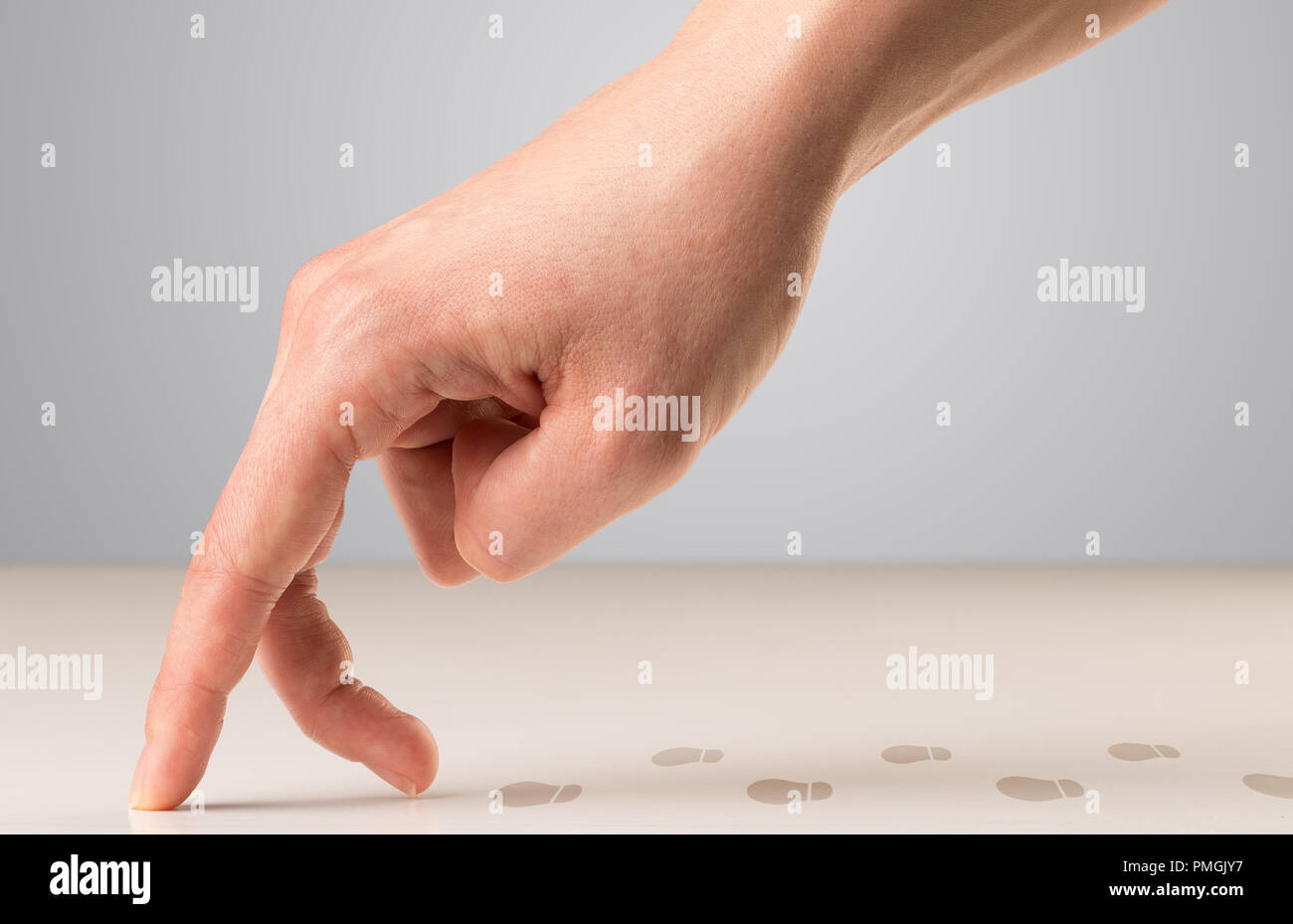 Female fingers walking with footsteps behind them Stock Photo - Alamy