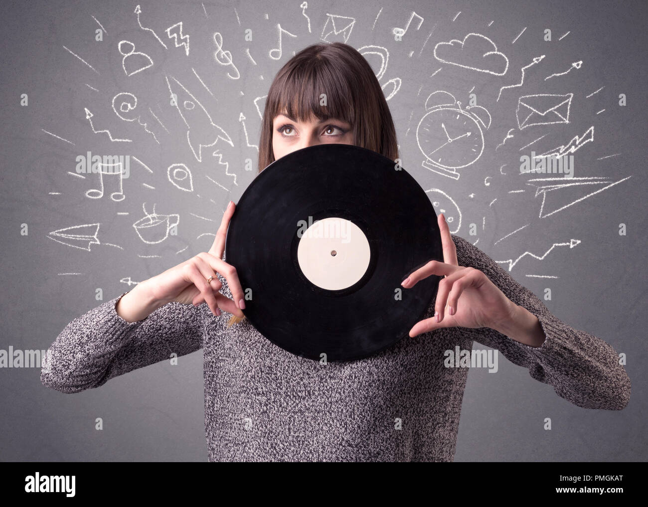 Young lady holding vinyl record on a grey background with mixed ...