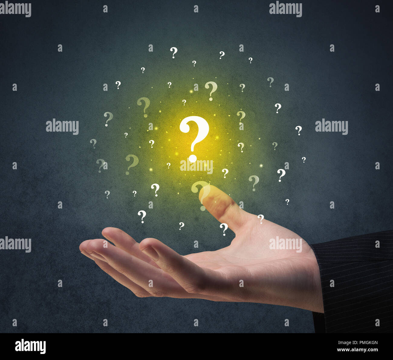 Yellow question marks hovering over young hand Stock Photo - Alamy