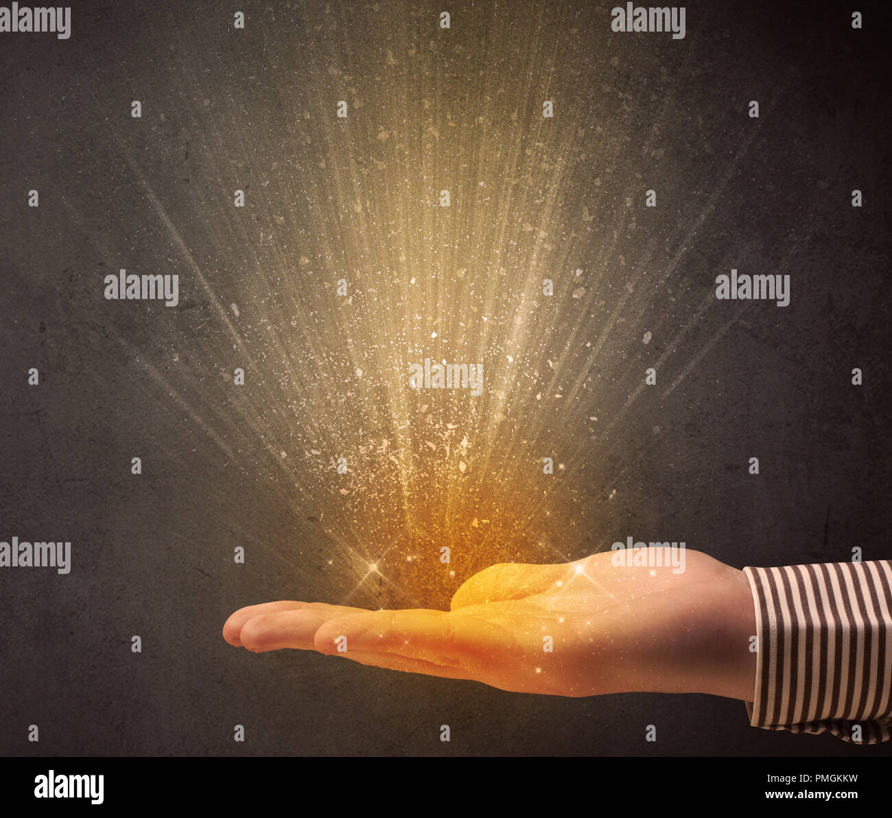 Yellow ray of light coming from a young hand Stock Photo - Alamy