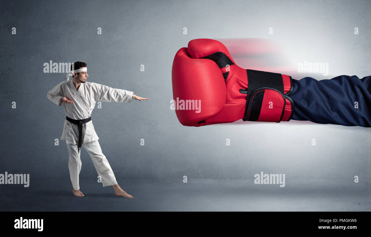 Little man fighting with a giant red boxing glove Stock Photo - Alamy