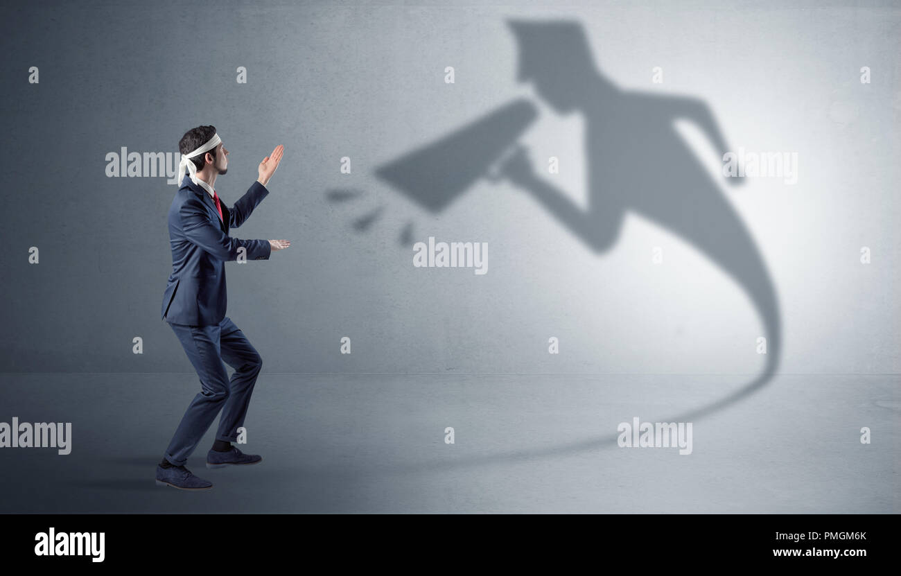 Businessman fighting with his bossy yelling shadow Stock Photo - Alamy