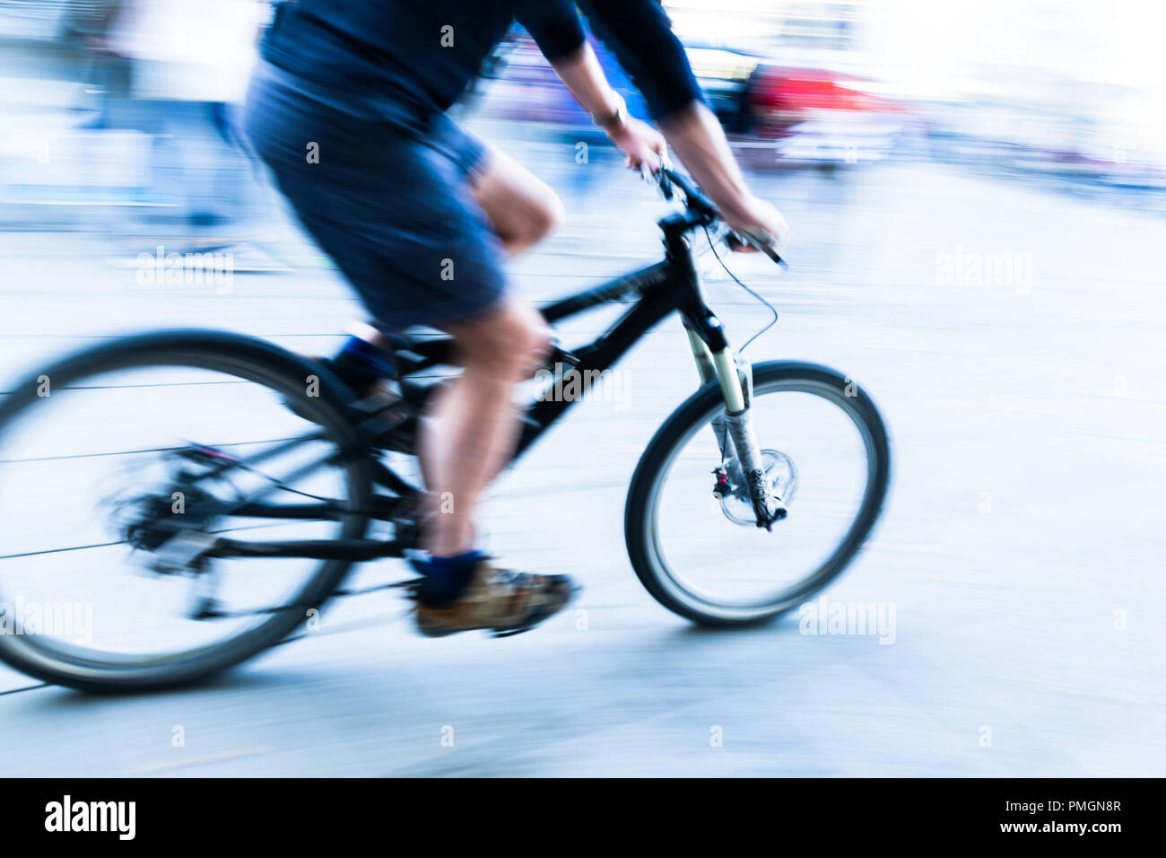 bicycle rider in the city in camera made motion blur Stock Photo - Alamy