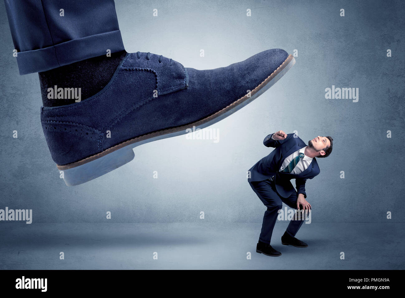 Big foot trying to crush small man who is afraid of that Stock Photo ...