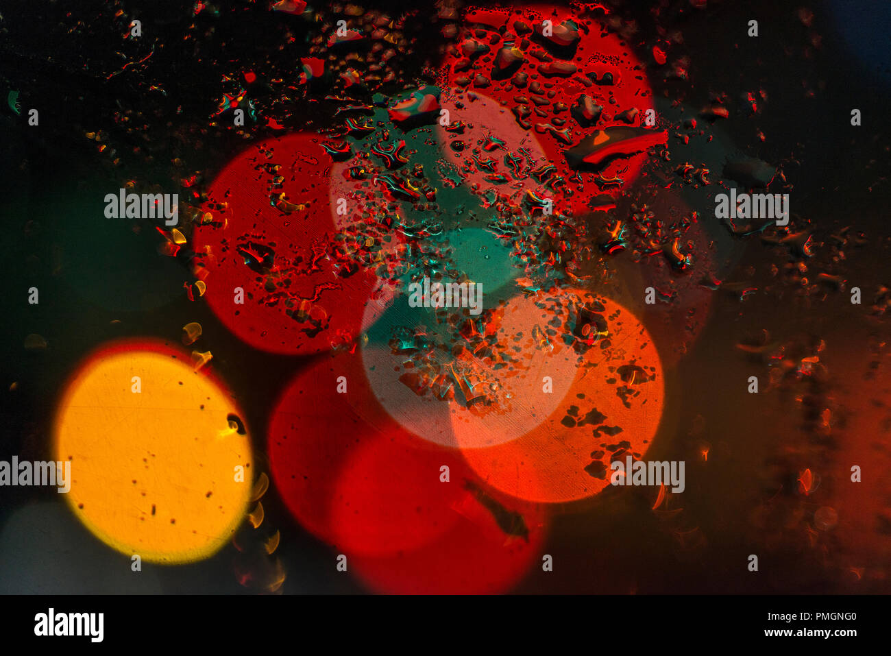 colored lights of cars and traffic lights through the windshield with ...