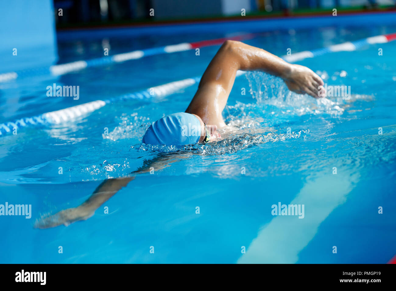 Image of athlete man in blue cap swimming in pool Stock Photo - Alamy