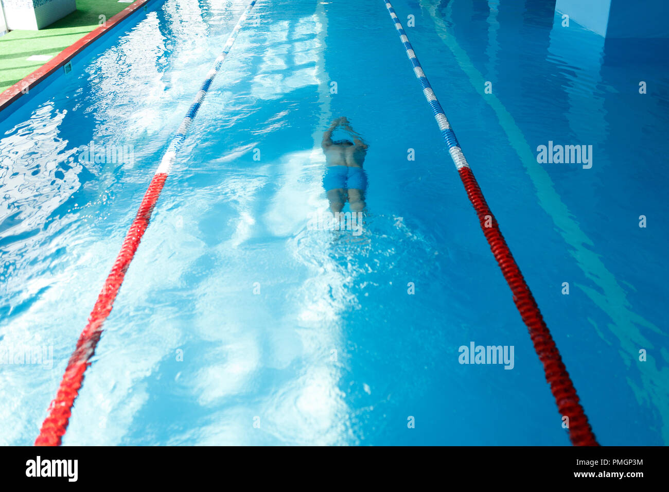 Photo of sports man swimming on path in pool Stock Photo - Alamy