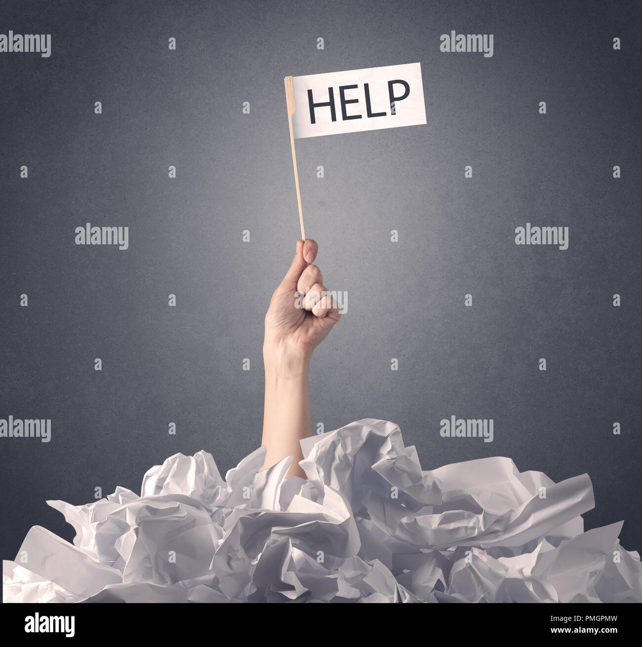 Female hand emerging from crumpled paper pile holding help sign Stock ...