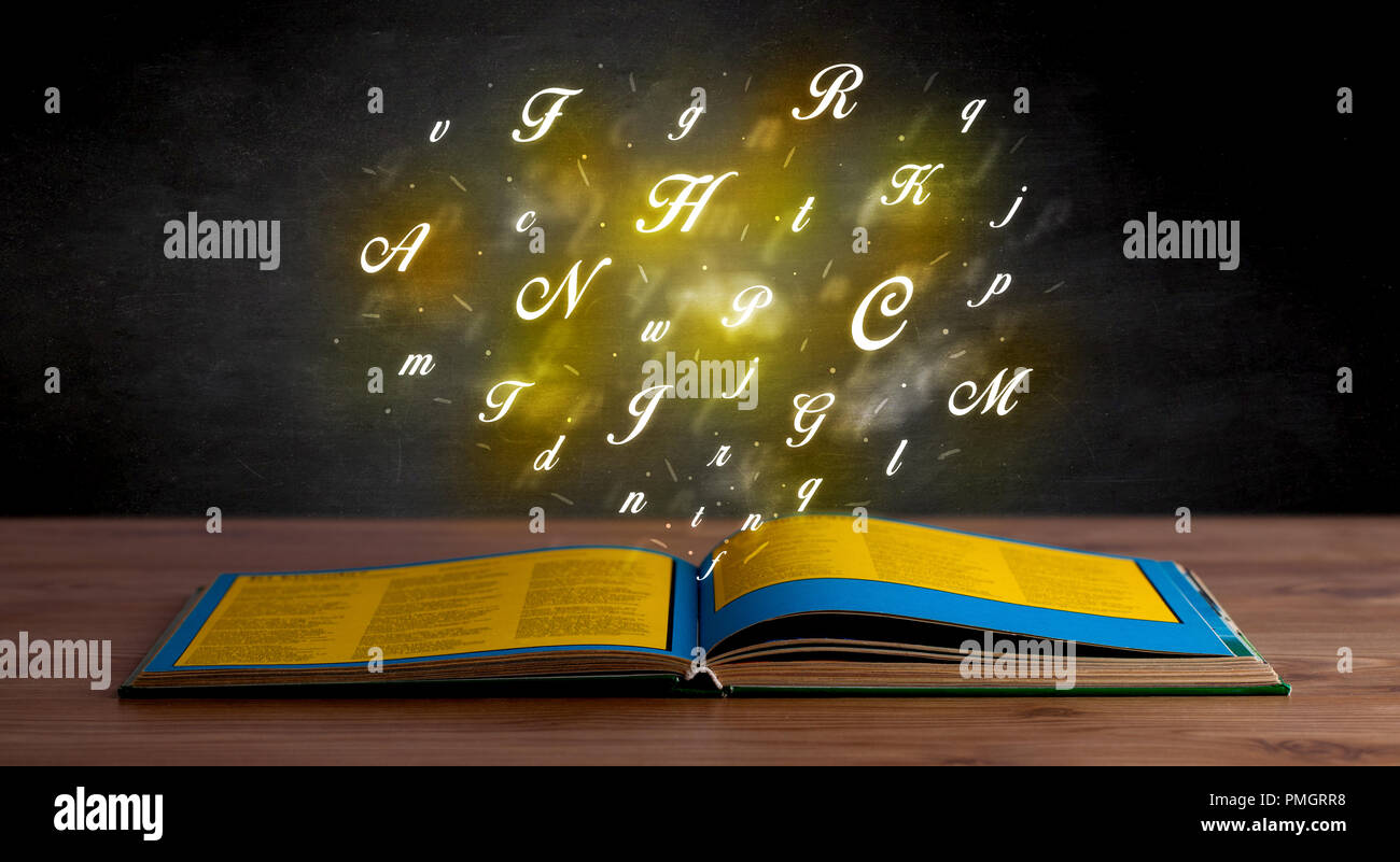 Glowing yellow alphabet letters coming out of an open book Stock Photo ...