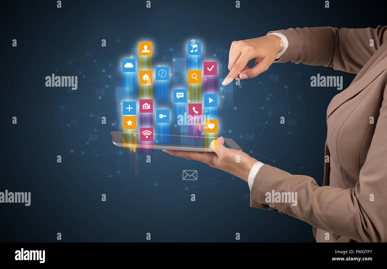 Female elegant hand holding tablet with colourful application icons ...