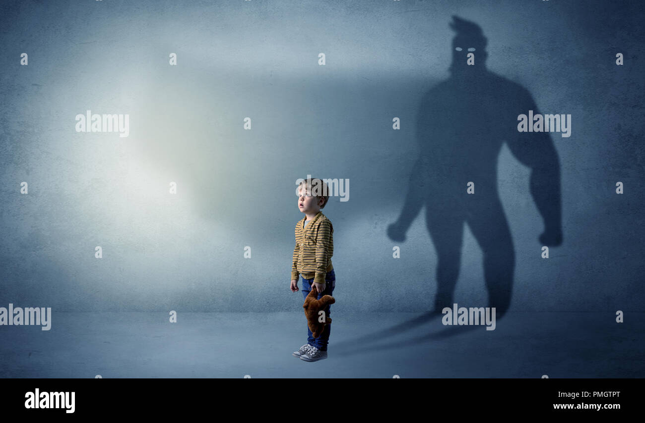 Cute kid in a room with plush on his hand and hero shadow on his ...